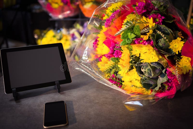 Flower Bouquet with Smartphone and Digital Tablet on the Table Stock ...