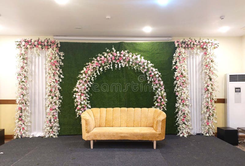 Flower Decoration on Green Grass Wall with Sofa in Banquet Hall Stock ...