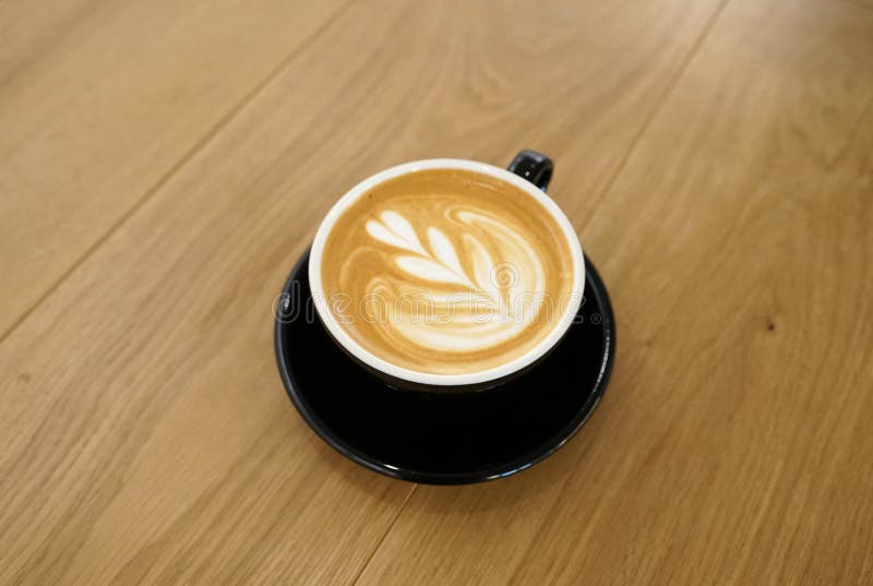 Flower Pattern Latte Art on Hot Coffee Latte Serving on Black Cu Stock ...
