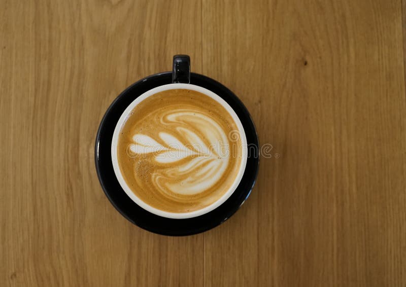 Flower Pattern Latte Art on Hot Coffee Latte Serving on Black Cu Stock ...