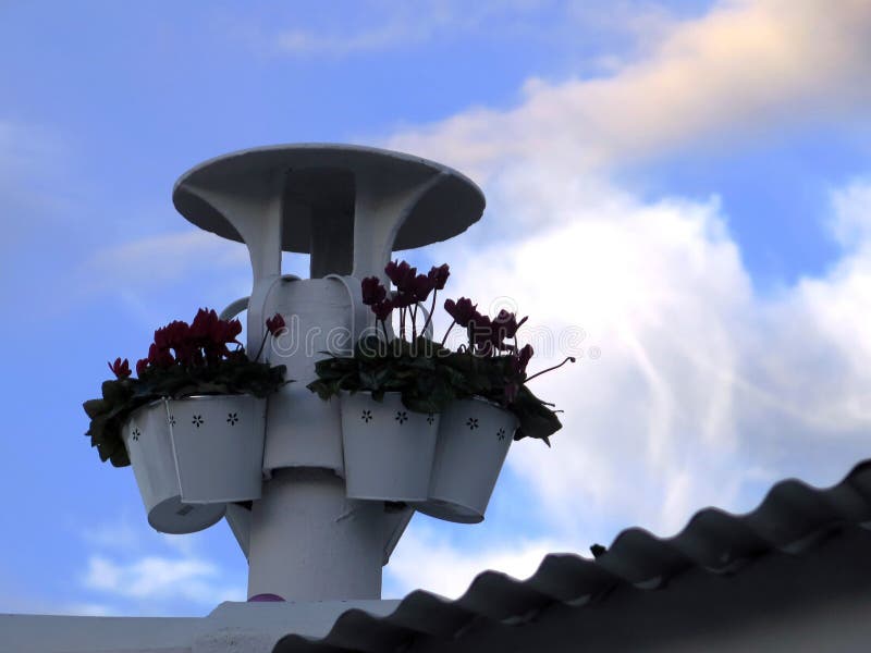 Flower pots on chimney stock photo. Image of flowers - 82585826
