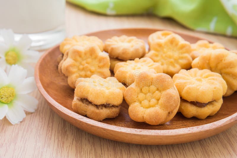 Flower Shape Biscuits with Jam Filling on Wooden Plate Stock Image ...