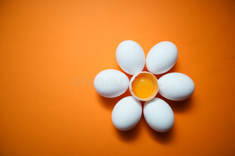 Flower Shaped Raw Egg on Orange Background. Few White Eggs, Whole and ...