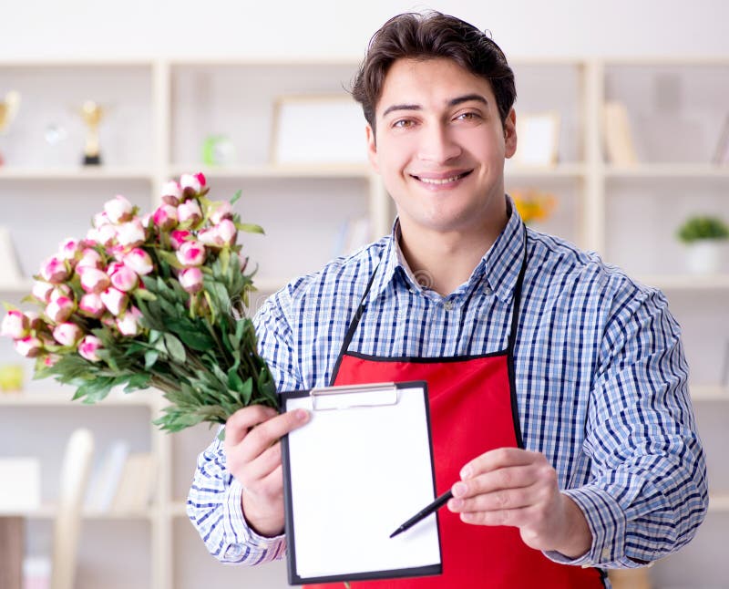Flower Shop Assistant Offering a Bunch of Flowers Stock Photo - Image ...