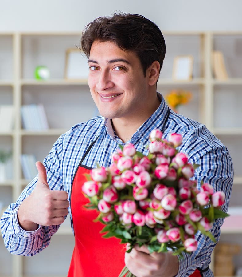 Flower Shop Assistant Offering a Bunch of Flowers Stock Image - Image ...