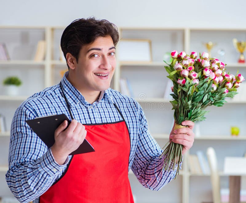 Flower Shop Assistant Offering a Bunch of Flowers Stock Photo - Image ...