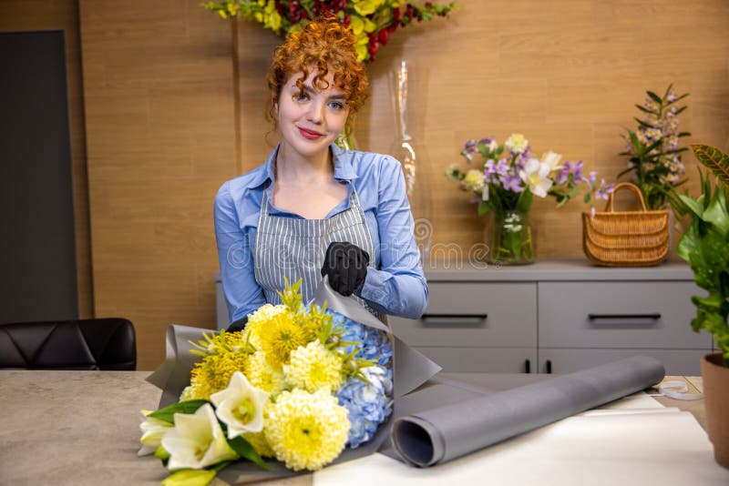 Cute Ginger Young Woman Standing at the Table in a Flower Shop Stock ...