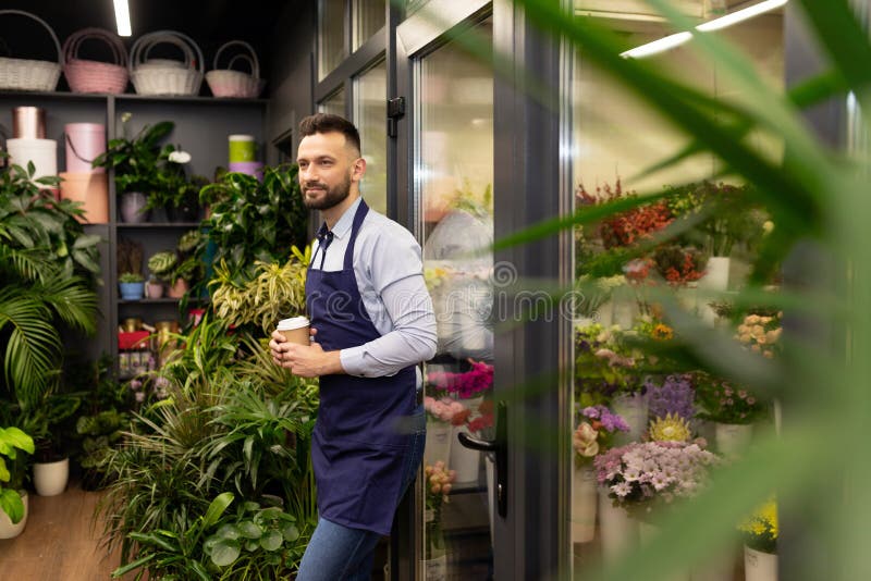 Flower Shop Employee Resting between Orders Leaning on the Refrigerator ...