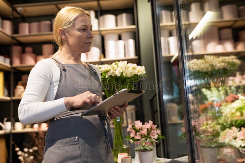 Flower Shop Manager Doing Inventory with Tablet Stock Photo - Image of ...
