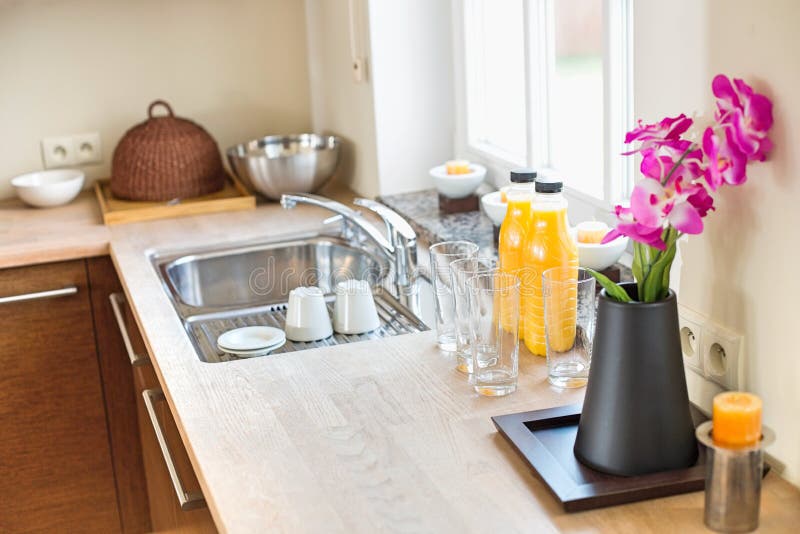 Flower Vase with Juice Bottles on Kitchen Counter Stock Image - Image ...