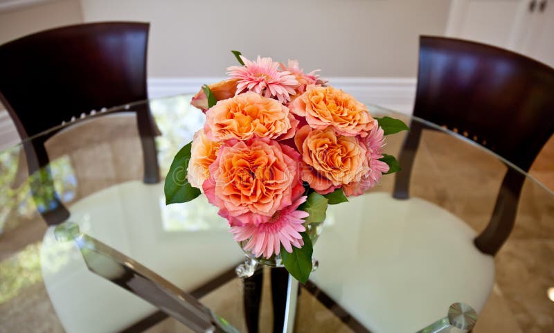 Flowers on glass table stock photo. Image of arranged - 21597190