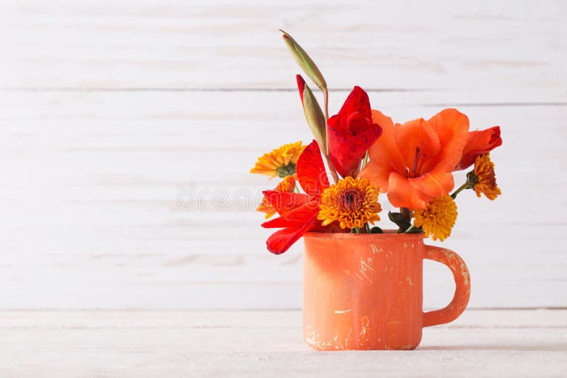Flowers in Orange Old Cup on Wooden Table Stock Image - Image of ...