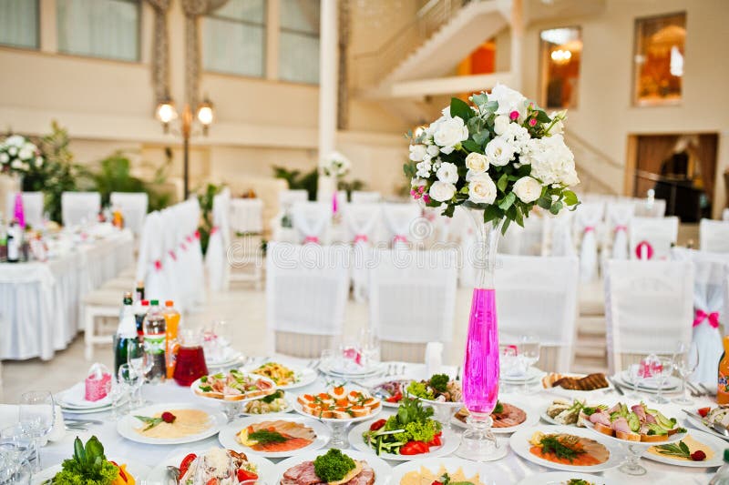 Flowers on Vase with Pink Water at Table of Wedding Guests. Stock Image ...