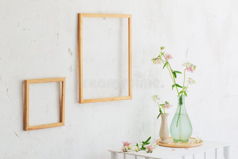 Flowers in Vase and Wooden Frames on White Interior Stock Photo - Image ...