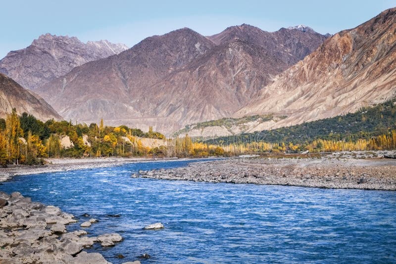 Flowing Blue Water of Gilgit River with Mountains in the Background ...