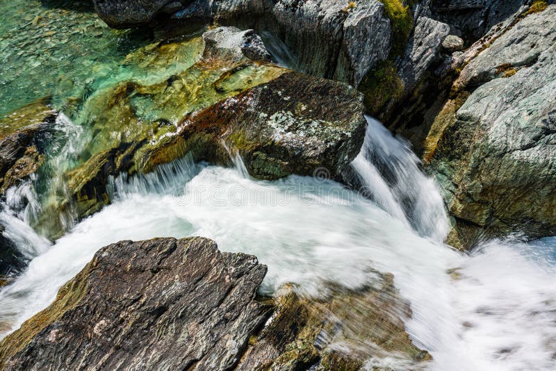 Flowing River Surrounded by Rocks Under the Sunlight at Daytime ...