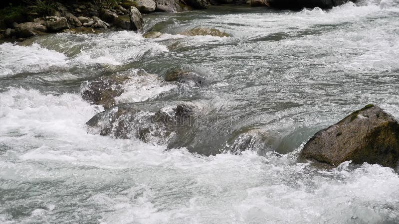 White Water Rushes Around Rocks in a Fast Flowing River Stock Video ...