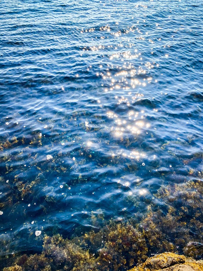 Flowing Sea Water Surface with Sun Rays Reflecting on it Stock Photo ...