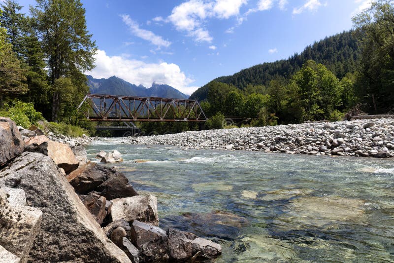 Flowing Skykomish River with Cascade Mountains and Old Bridge in ...