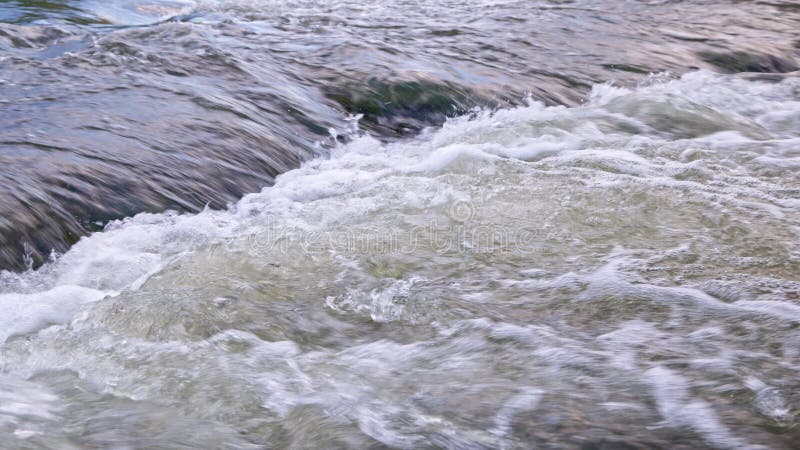 The Flowing Water of a Summer River with a Small Rapid Waterfall in ...