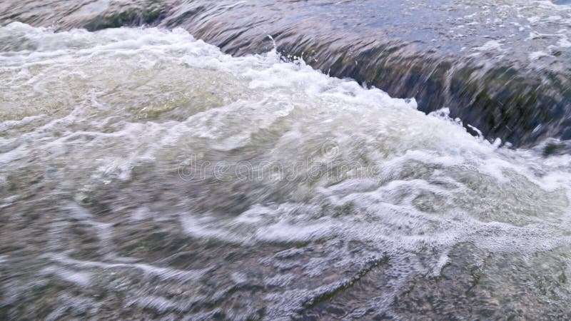 The Flowing Water of a Summer River with a Small Rapid Waterfall in ...
