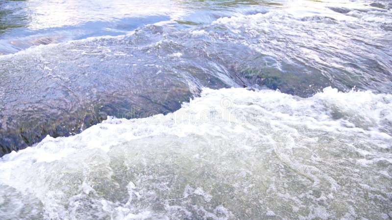 The Flowing Water of a Summer River with a Small Rapid Waterfall in ...