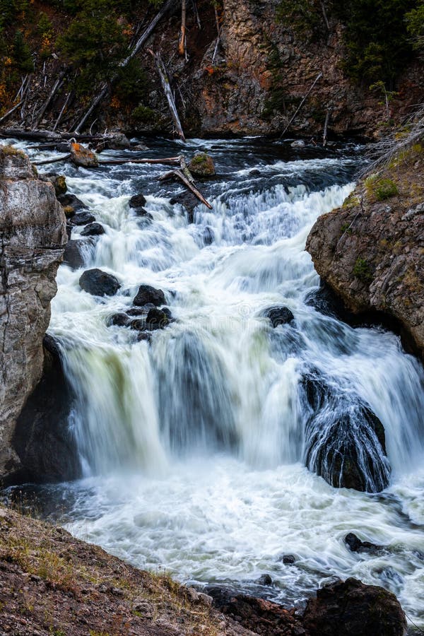 Flowing Waterfall in Blurry Motion Over Black Rock River Stock Image ...