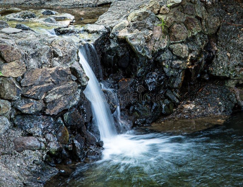 Flowing Waterfall Over Rocks To a Small Pond Stock Image - Image of ...