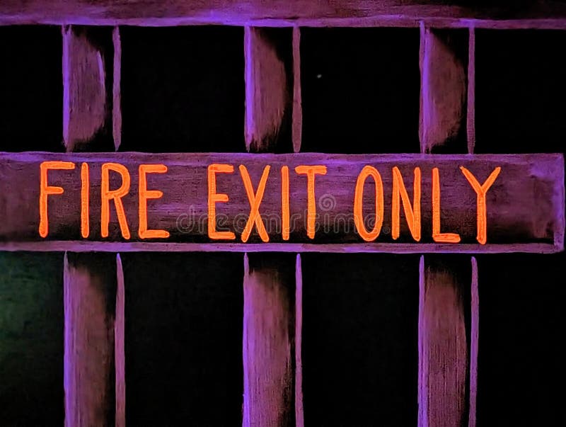 Fluorescent Glowing Fire Exit only Sign Stock Photo - Image of pink ...