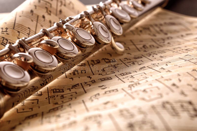 Flute and Old Sheet Music on Black Table Front Elevated View Stock ...