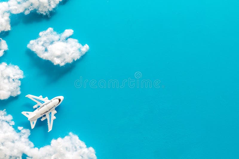 Fly by Plane Concept. Airplane Model and Clouds on Blue Background Top ...