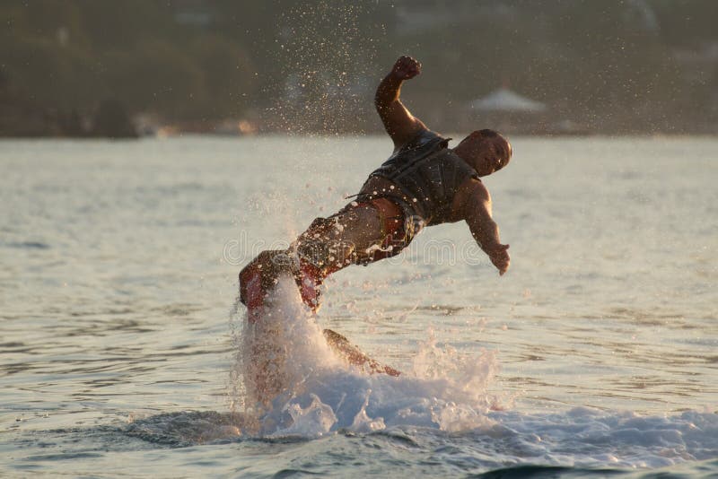 Flyboarder with Arms Out Twisting Towards Water Stock Photo - Image of ...