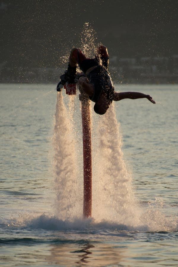 Flyboarder Doing Back Flip Surrounded by Spray Stock Image - Image of ...