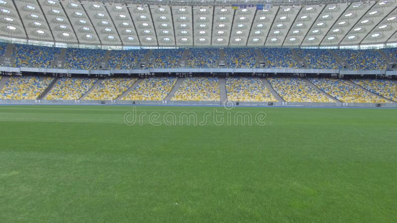 Flying Above Grass on a Small Height Inside Huge Modern Empty Stadium ...