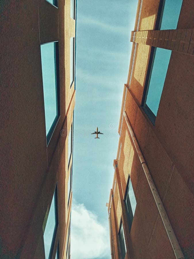 Flying Aeroplane Near Building Stock Photo - Image of flying, hospital ...