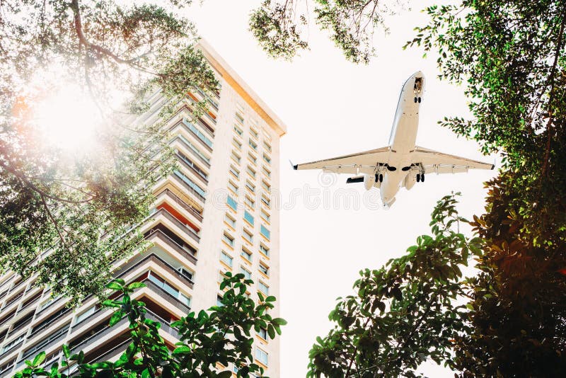 Flying airplane over city stock photo. Image of summer - 73869914