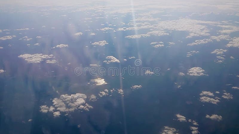 Flying in an Airplane. View of the Clouds from High Above, through the ...