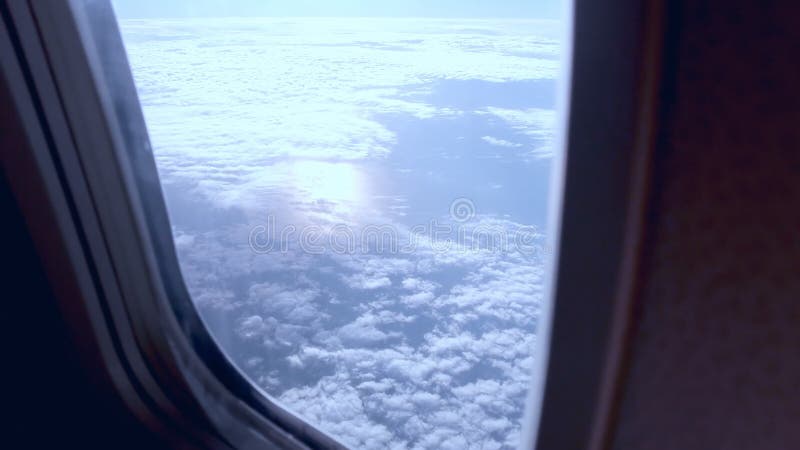 Flying in an Airplane, View of the Ground with Clouds from Above from ...