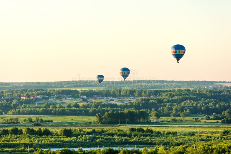 Flying in a Balloon. Three Balls Flying on the Green Fields and Forest ...