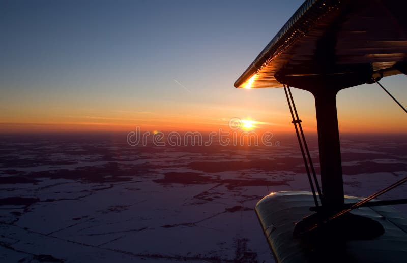 Flying a biplane at sunset stock photo. Image of power - 31245228