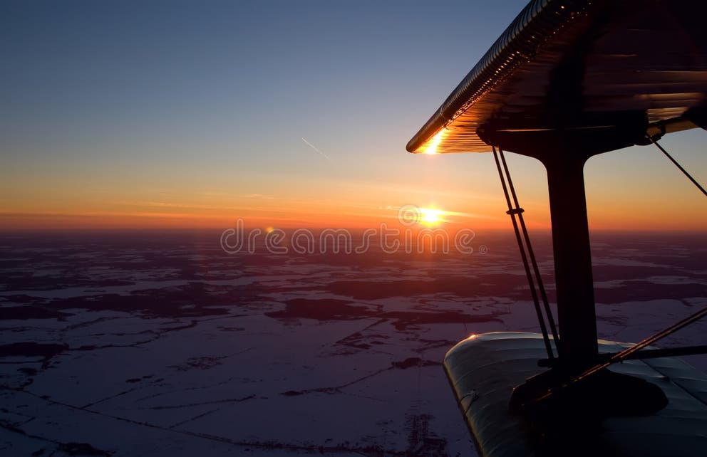 Flying a biplane at sunset stock photo. Image of power - 31245228