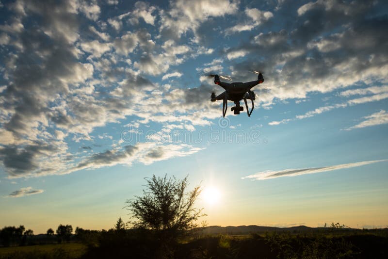 Flying drone in the sunset stock image. Image of drone - 105475869