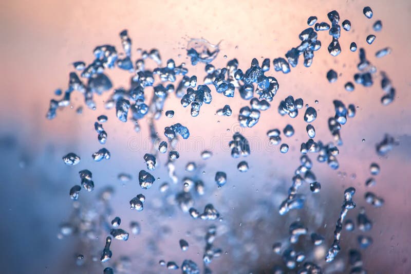 Flying Drops of Water Fountain Close-up on the Background of the Sky ...