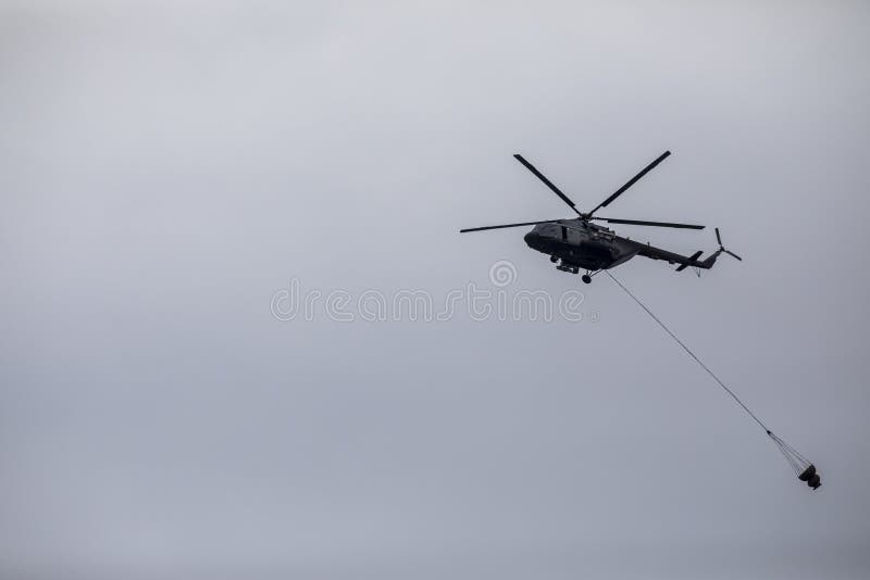 Firefighter Helicopter with a Water Tank in Smoke from a Fire Stock ...