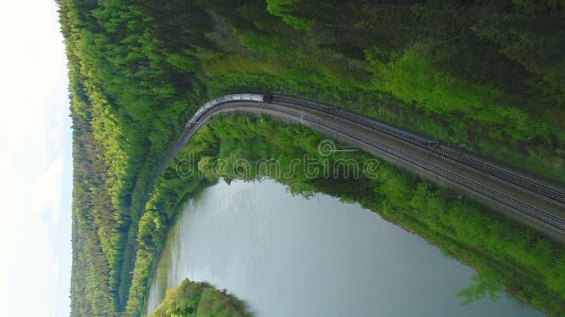 Flying Forward and Downward Over Passing Train. Aerial View. Vertical ...