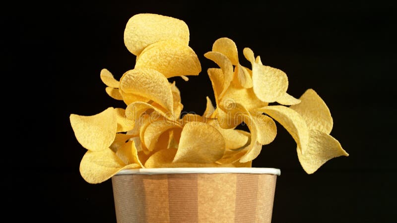 Exploding Potato Chips in Motion Against Dark Background Stock Image ...