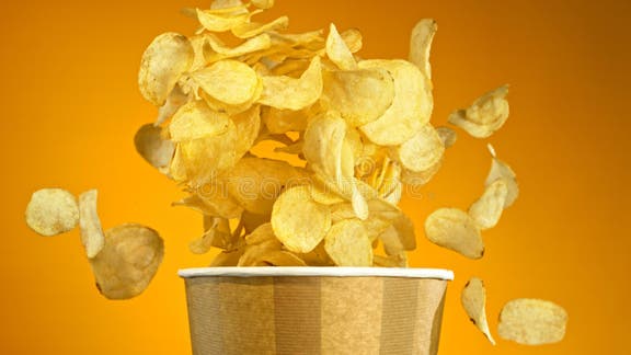Flying Fried Potato Chips Exploding from Paper Bucket. Stock Image ...