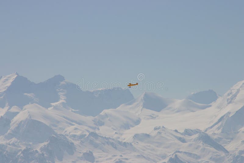 Flying in the mountains stock photo. Image of altitude - 927056