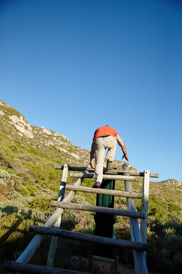 Flying through the Obstacle Course. Rearview Shot of a Man Climbing ...
