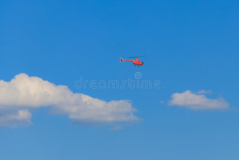 Flying Orange Helicopter in Blue Sky Stock Photo - Image of blue ...